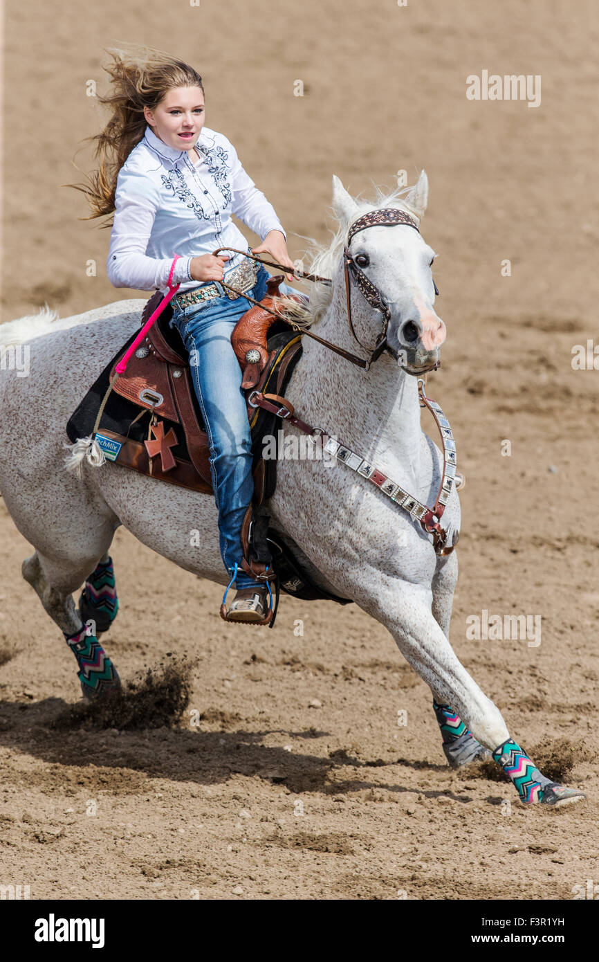 Rodeo cowgirl on horseback competing in barrel racing event, Chaffee ...