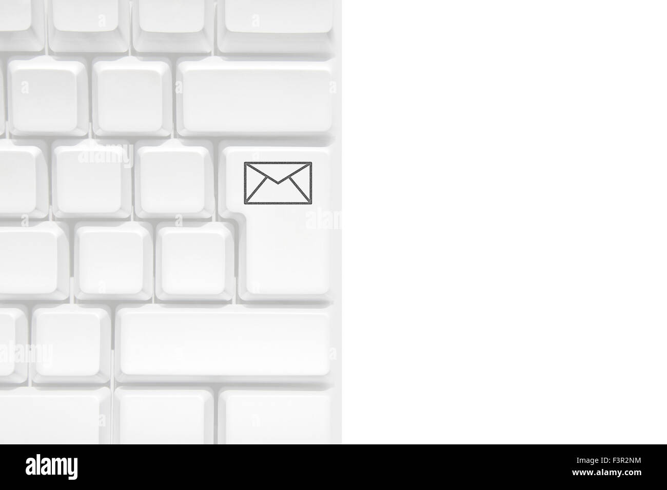 white computer keyboard with an email envelope design on the return key ...
