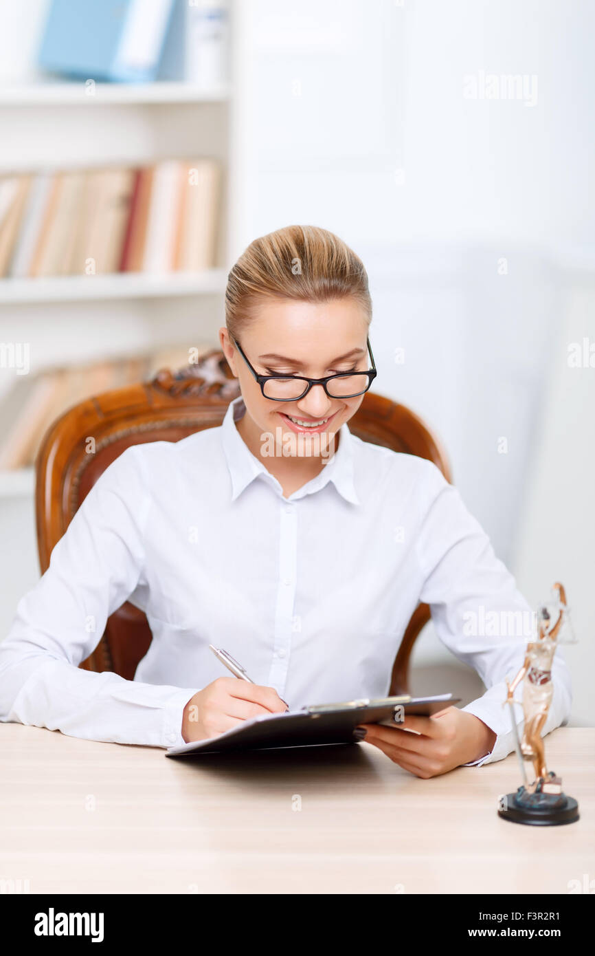 Charming lawyer sitting at the table Stock Photo - Alamy