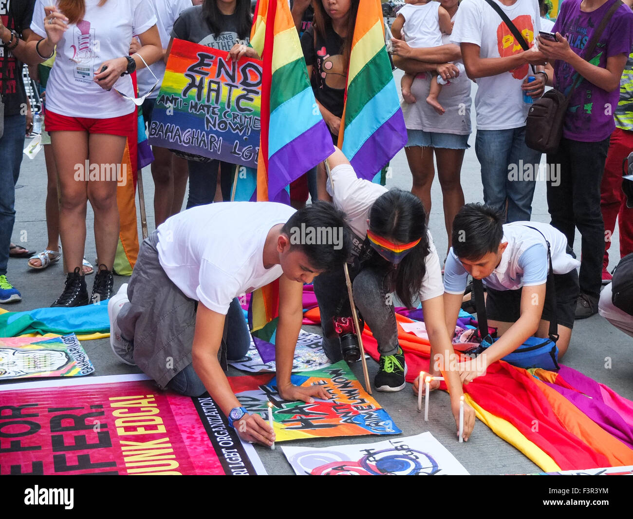 Makati City, Philippines. 11th Oct, 2015. Young protesters lighting ...
