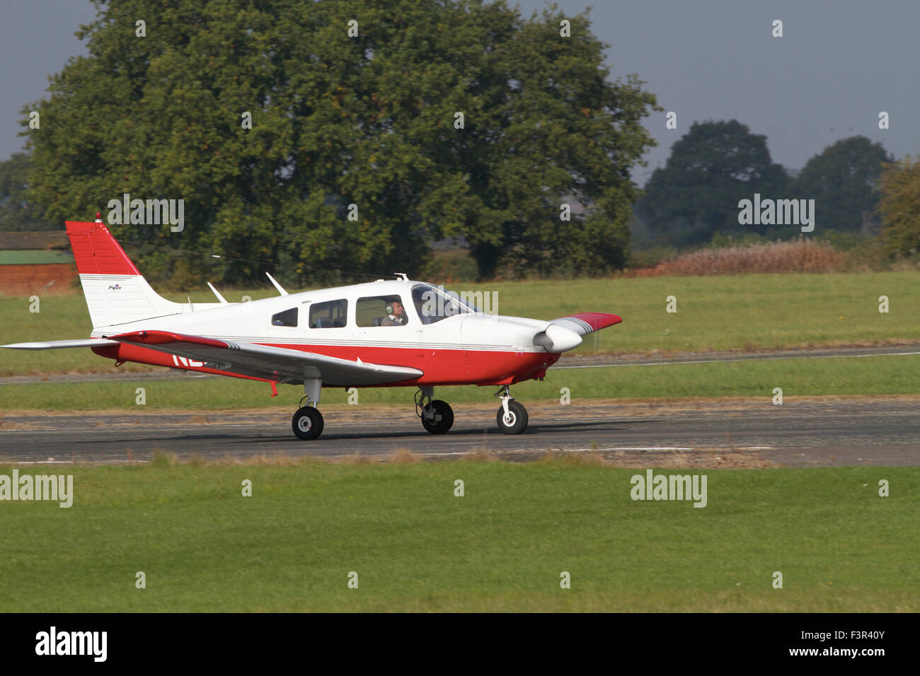 Single engined light aircraft taking off along runway. Wolverhampton ...