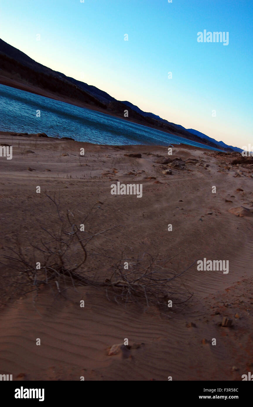 Receding water levels in a lake during drought Stock Photo - Alamy
