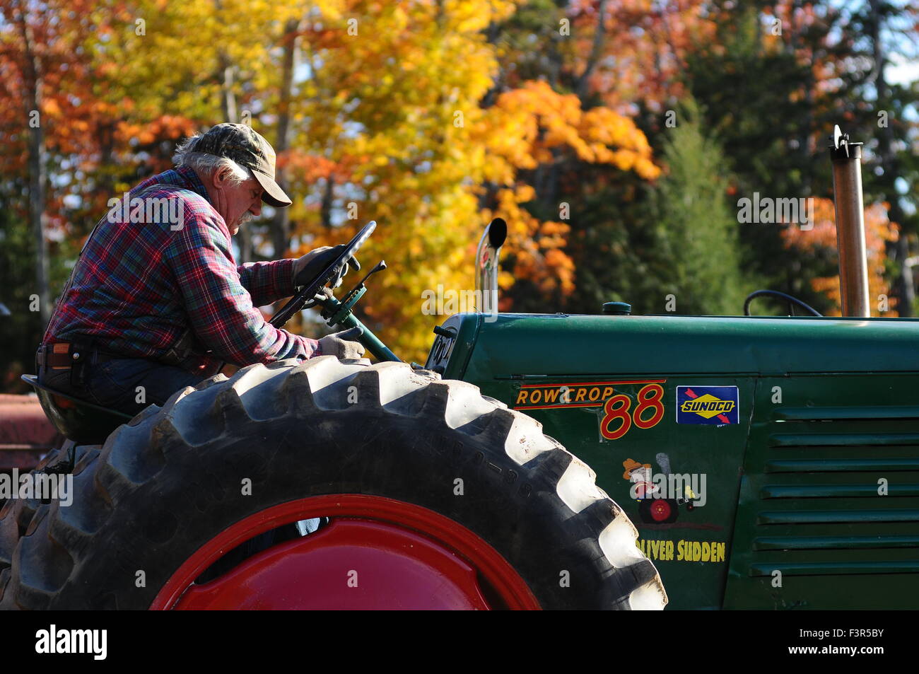 An American farmer drives an antique tractor in autumn Stock Photo - Alamy