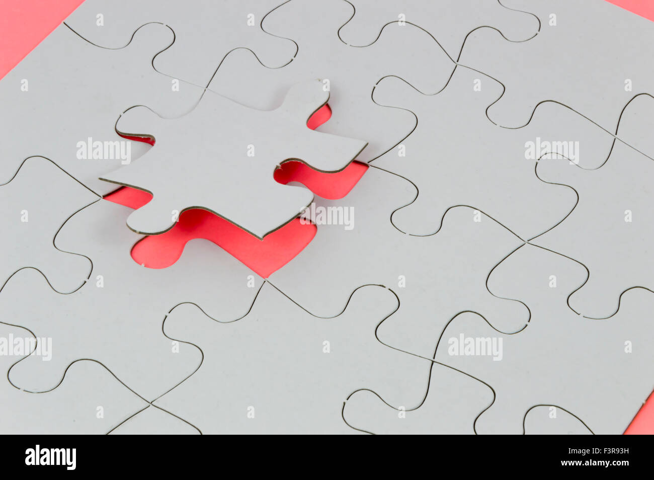 Plain white jigsaw puzzle, on Red background Stock Photo - Alamy