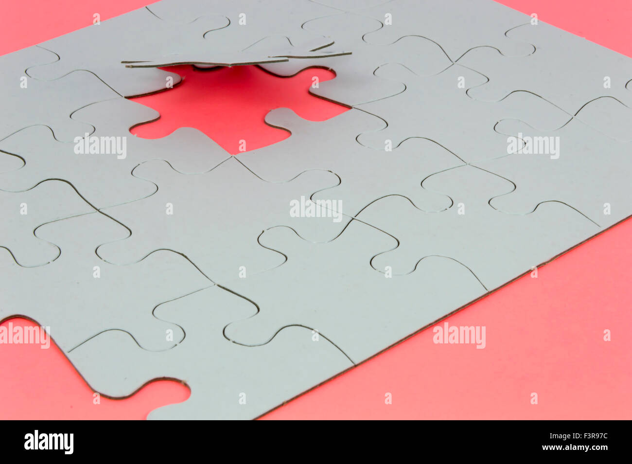 Plain white jigsaw puzzle, on Red background Stock Photo - Alamy
