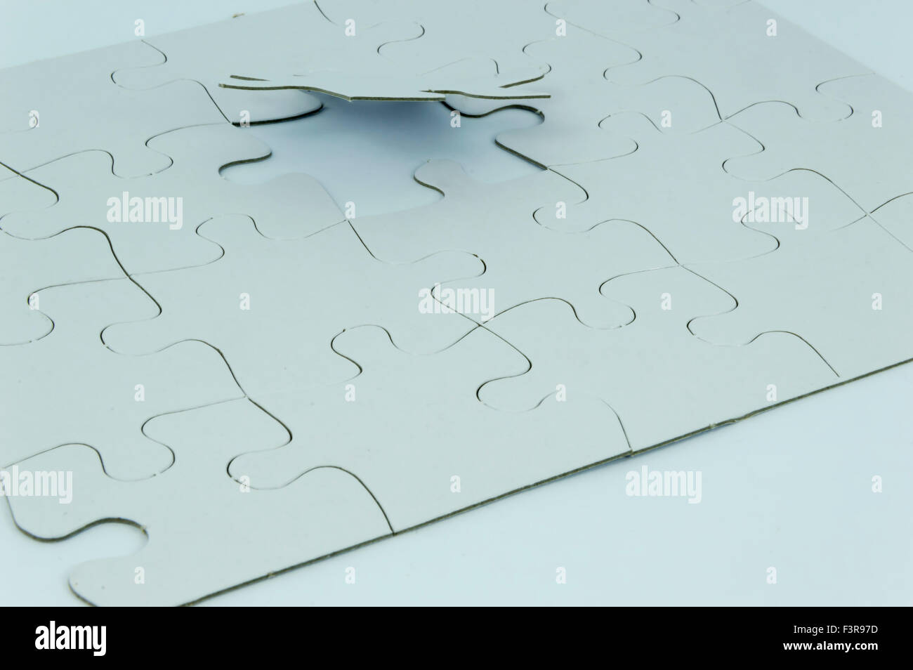 Plain white jigsaw puzzle Stock Photo - Alamy