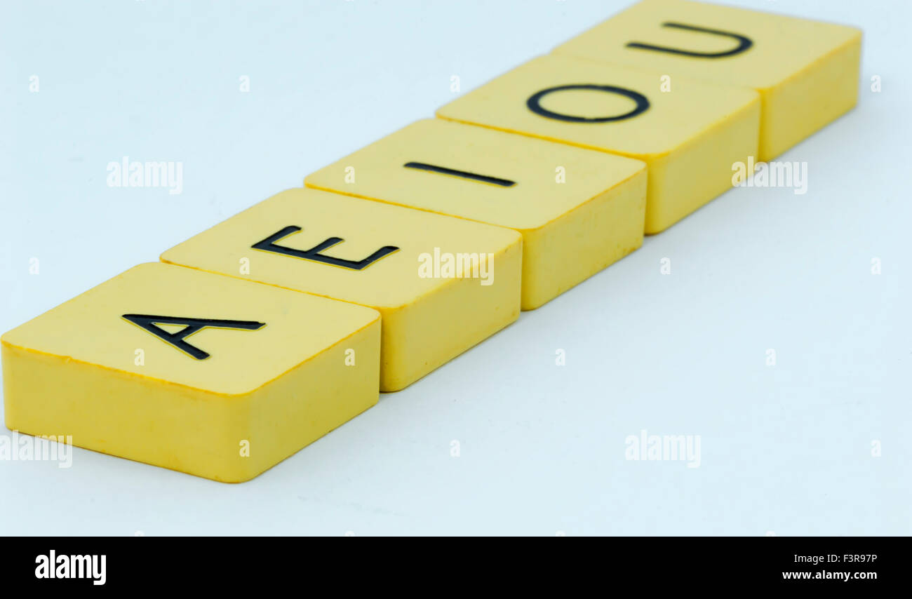 Yellow vowels cube with white background Stock Photo - Alamy