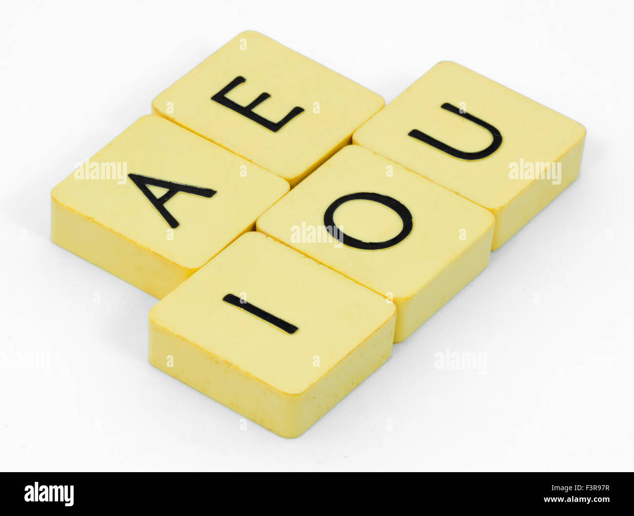 Yellow vowels cube with white background Stock Photo - Alamy
