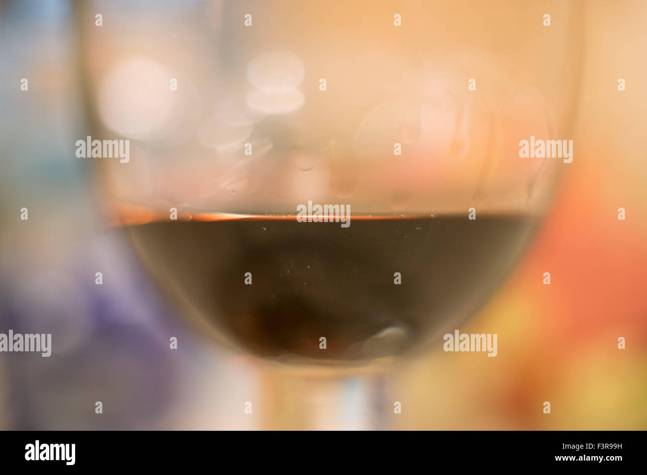 cup of wine with water droplets formed by the surface tension of ...