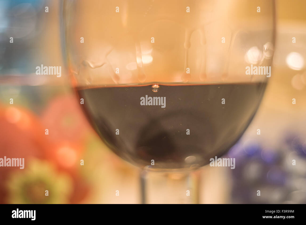cup of wine with water droplets formed by the surface tension of ...