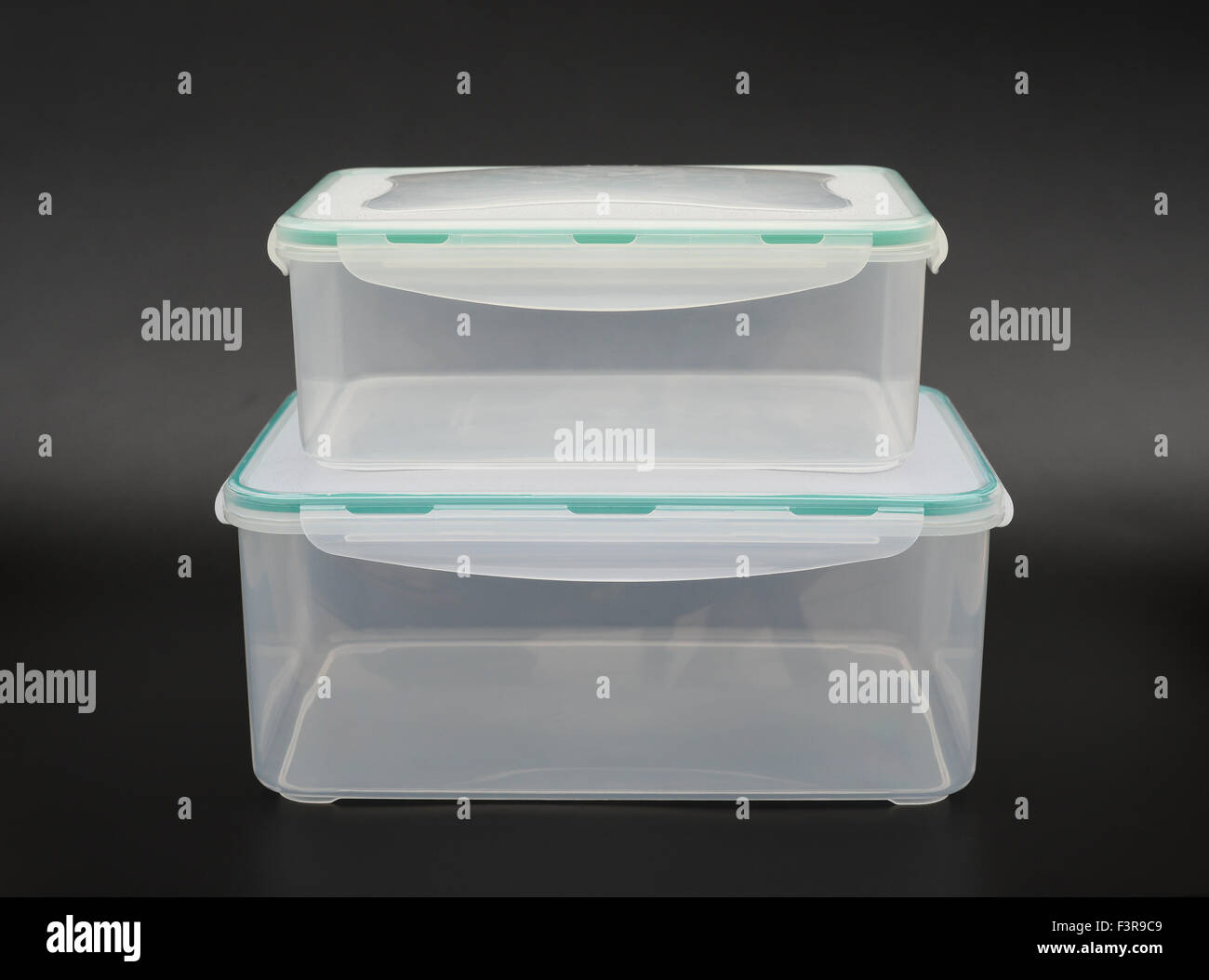 translucent storage boxes stack up on a black background Stock Photo ...
