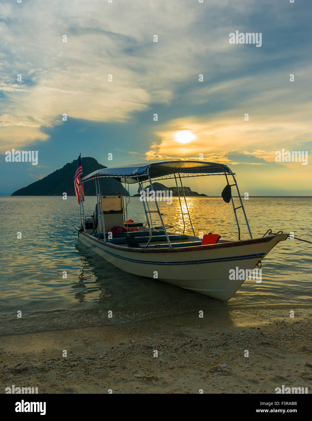 Boat with sunset background Stock Photo - Alamy