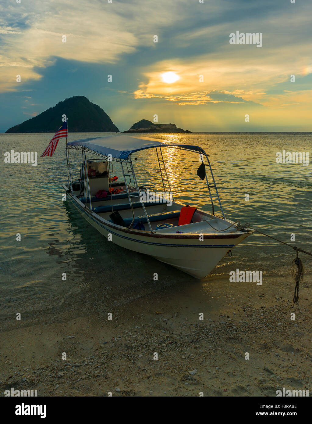 Boat with sunset background Stock Photo - Alamy