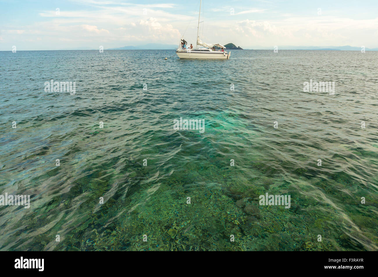 Clean and clear water with sail boats background. Low angle view Stock ...