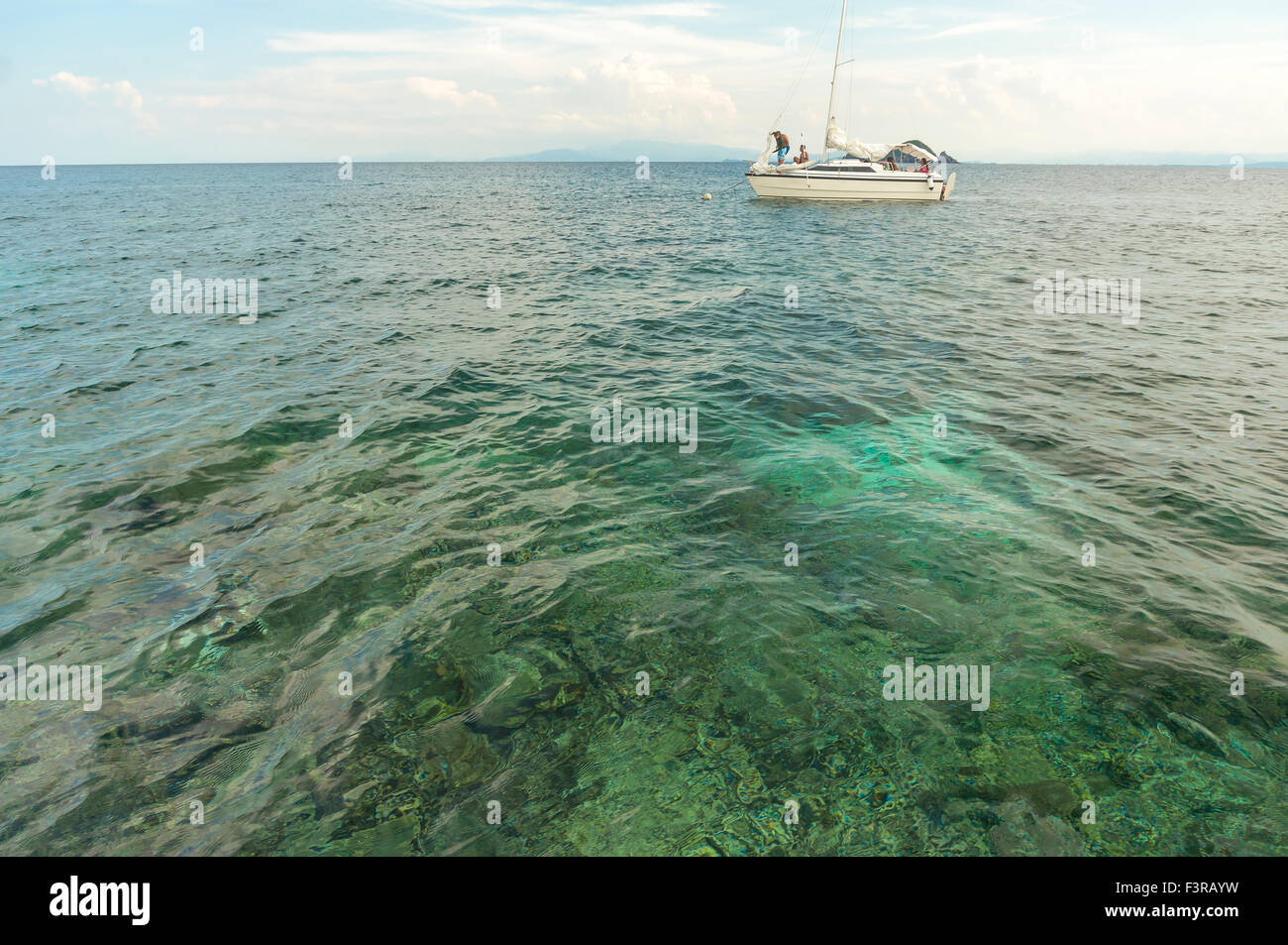 Clean and clear water with sail boats background. Low angle view Stock ...