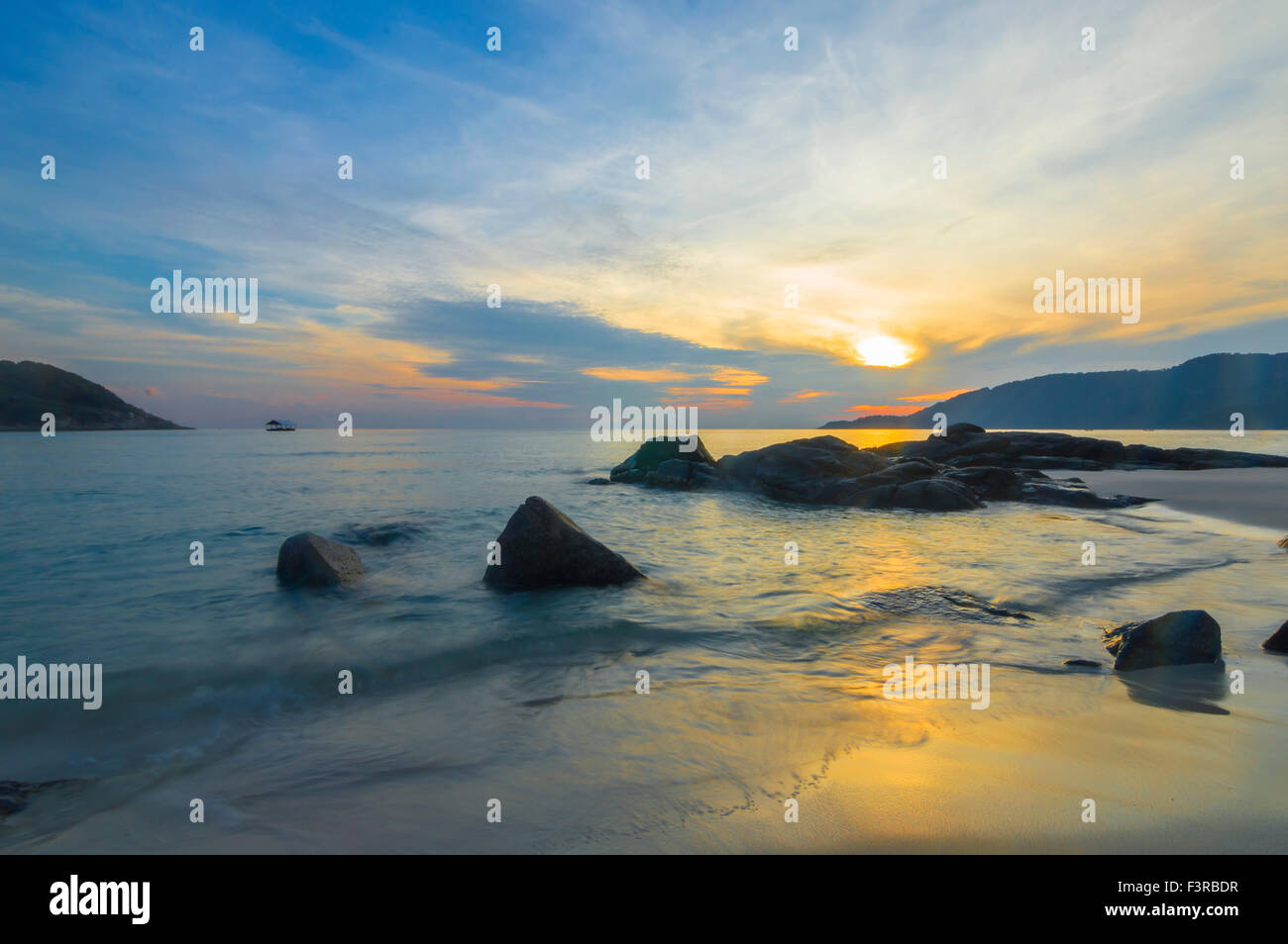 Beach rock and sunrise background Stock Photo - Alamy