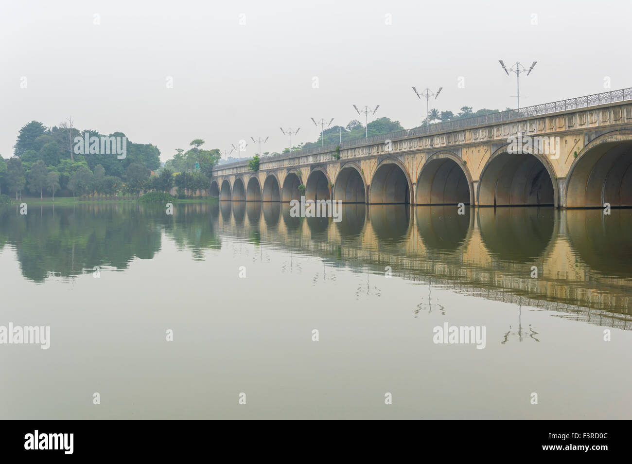 Under bridge and reflection with morning mist Stock Photo - Alamy