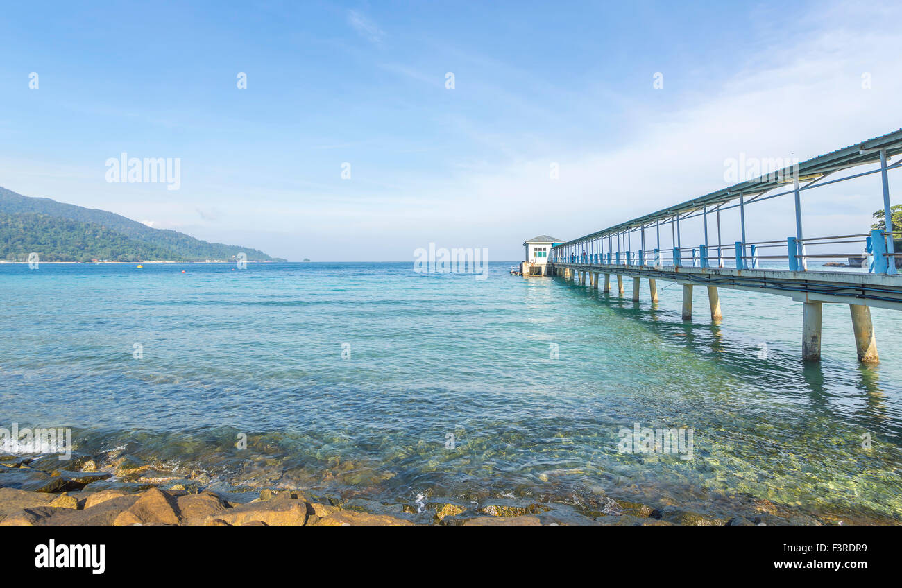 Jetty with clear water and blue skies Stock Photo - Alamy