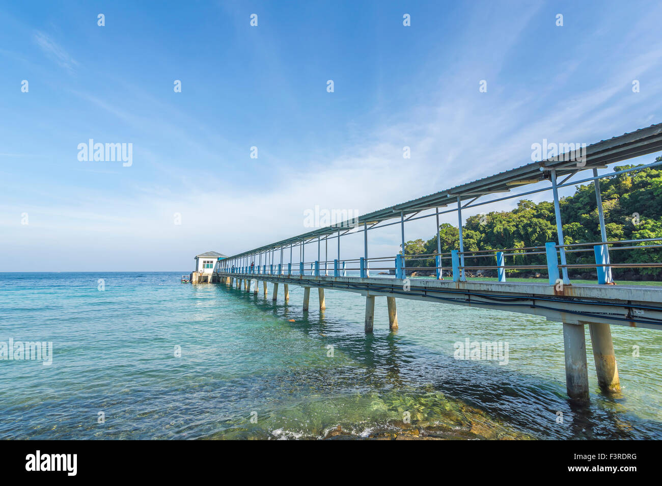 Jetty with clear water and blue skies Stock Photo - Alamy