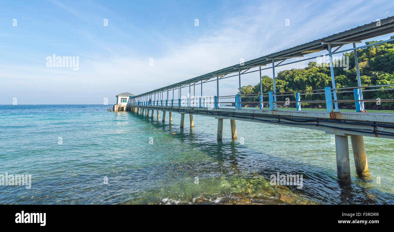 Jetty with clear water and blue skies Stock Photo - Alamy