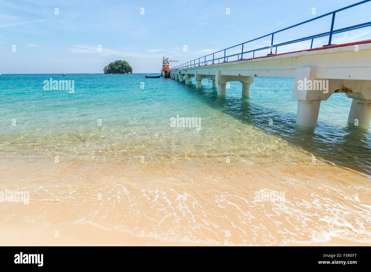 Jetty with clear water and blue skies Stock Photo - Alamy