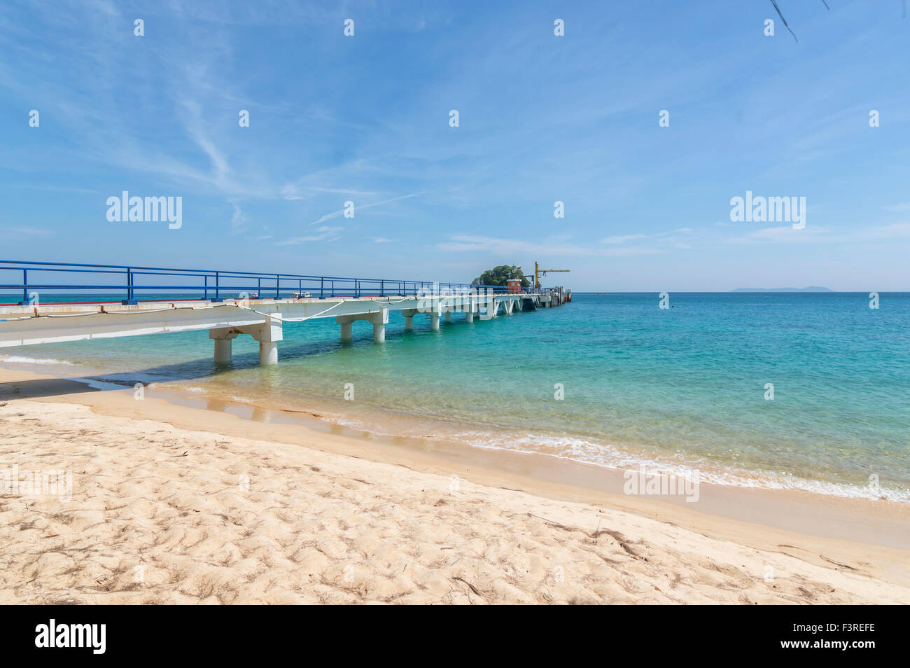 Jetty with clear water and blue skies Stock Photo - Alamy