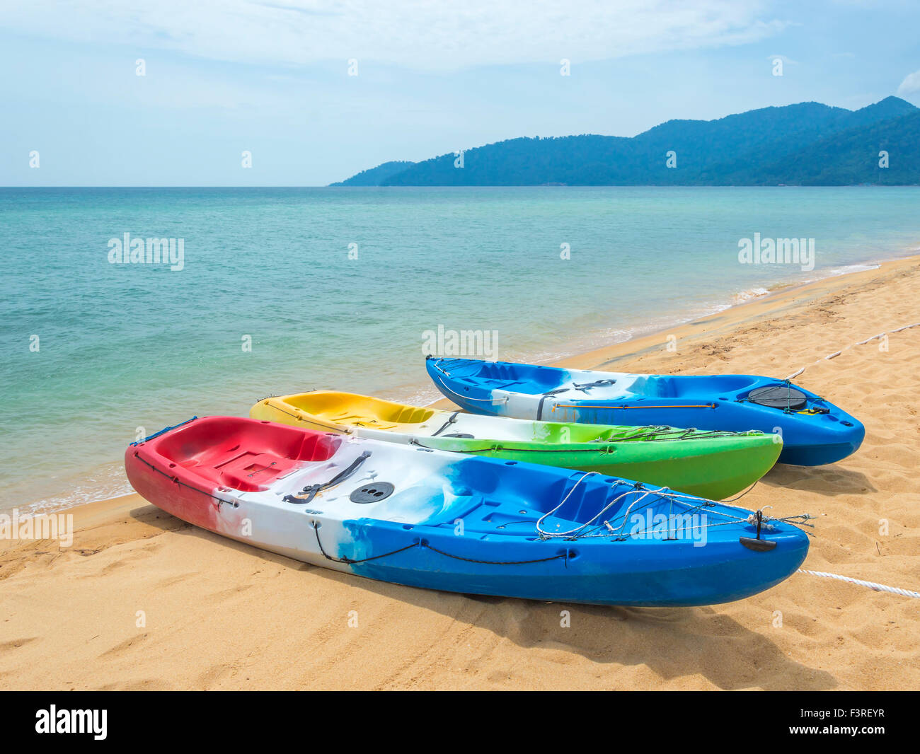 Row of colorful kayaks at sea shore Stock Photo - Alamy