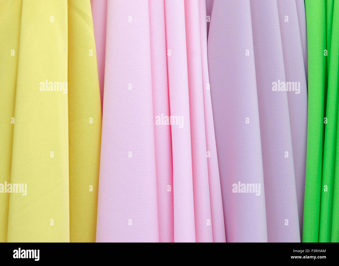Closeup of various fabric bolts in store Stock Photo - Alamy