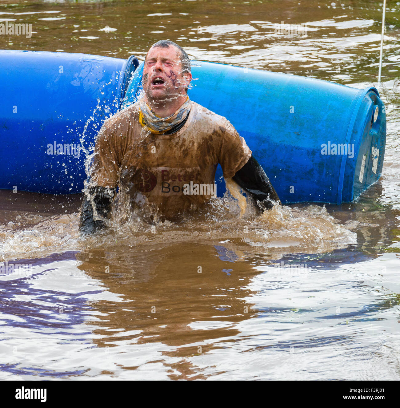 Competitor completing water obstacle Stock Photo - Alamy