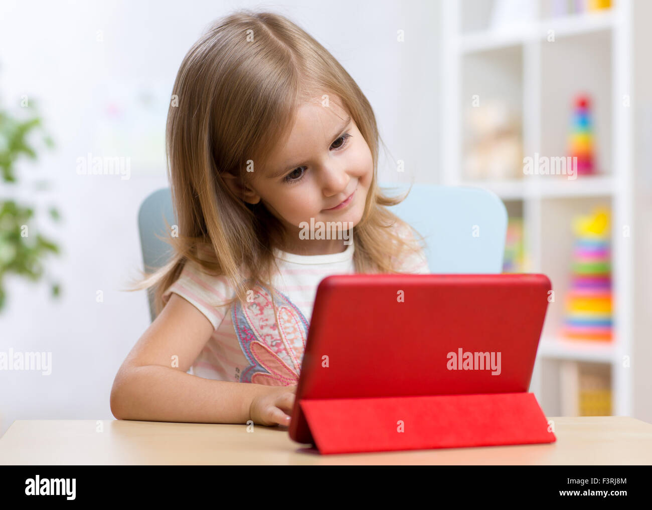 happy child little girl using tablet computer Stock Photo - Alamy
