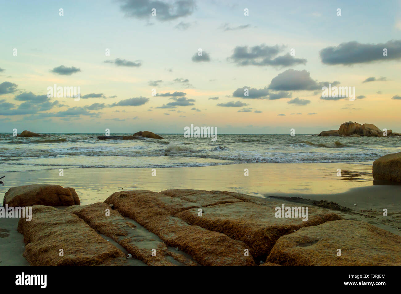 Beach rock with sunset background Stock Photo - Alamy