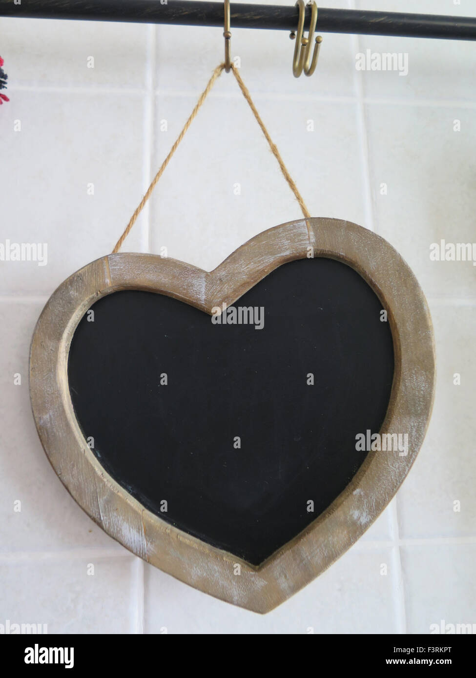 Wooden heart shaped slate hanging on string Stock Photo - Alamy