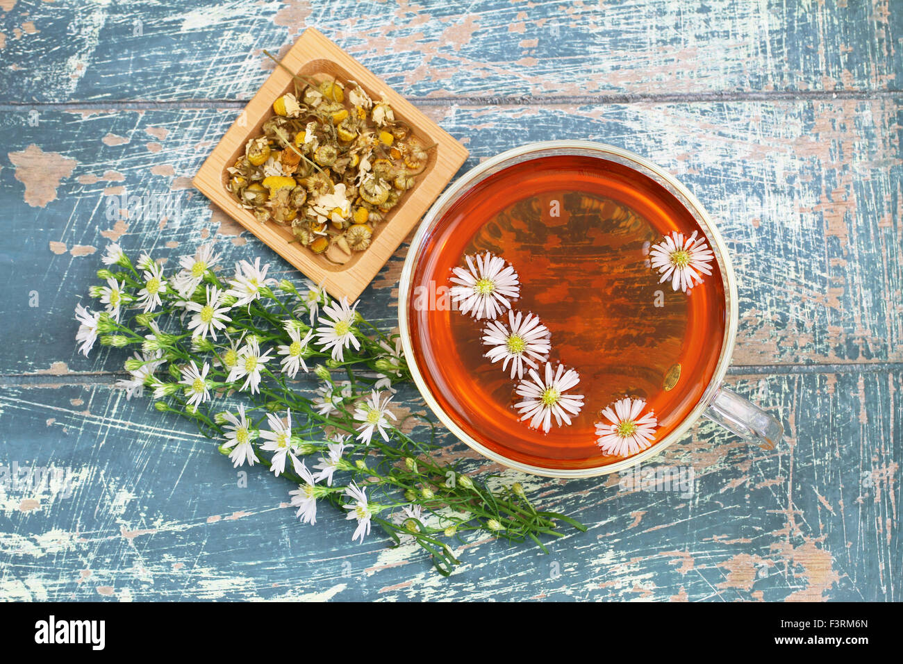 Chamomile tea with fresh and dried chamomile herbs on rustic wooden ...