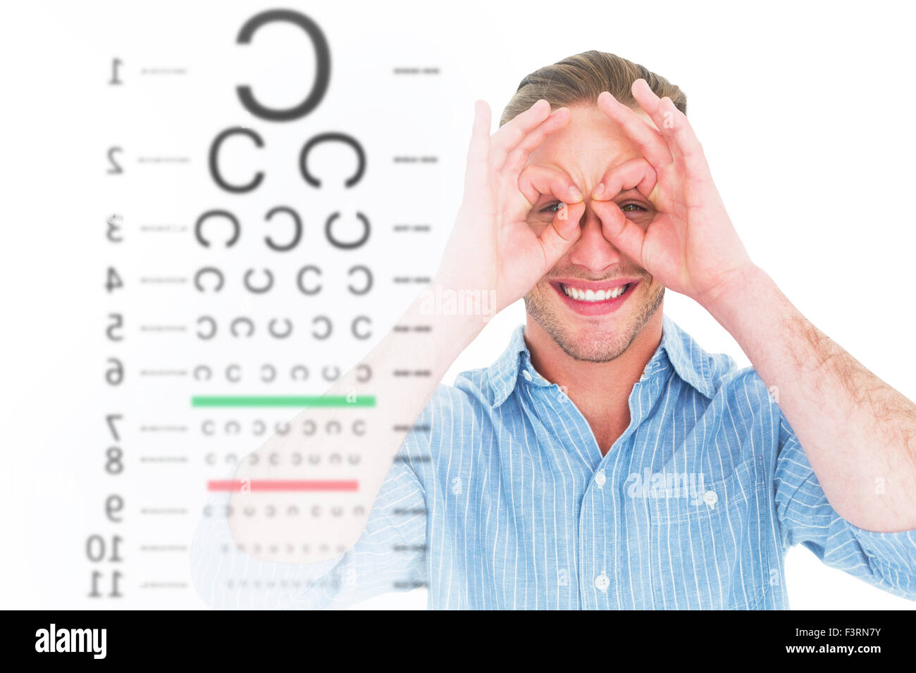Composite image of smiling doctor forming eyeglasses with his hands ...