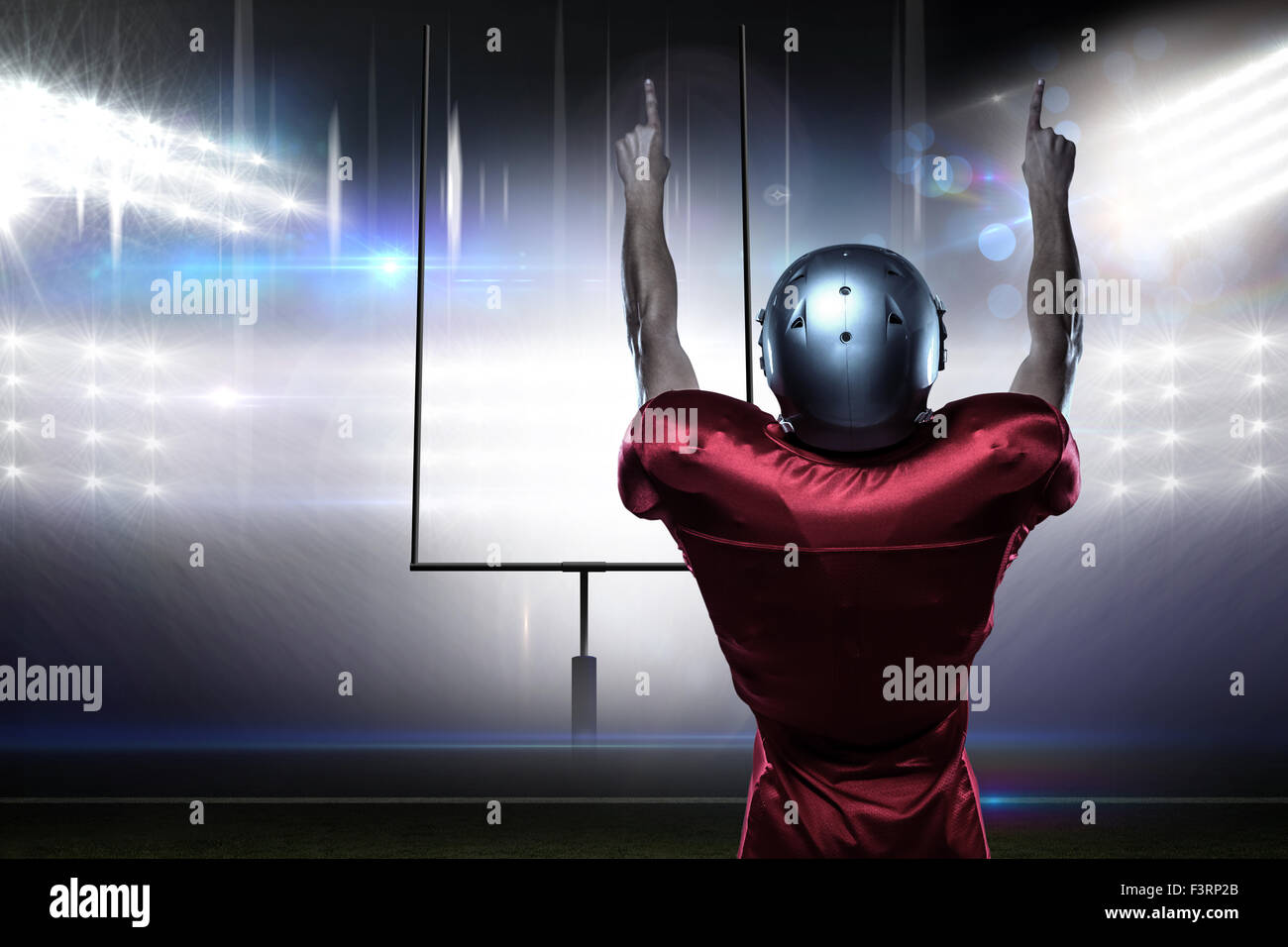 Composite image of rear view of american football player with arms ...
