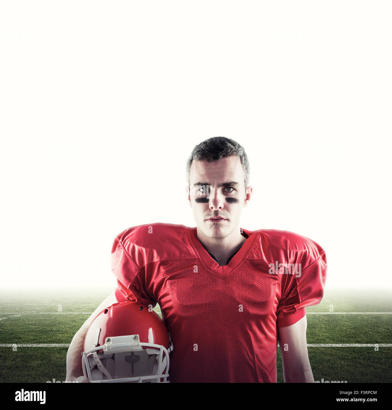 Composite image of a serious american football player looking at camera ...