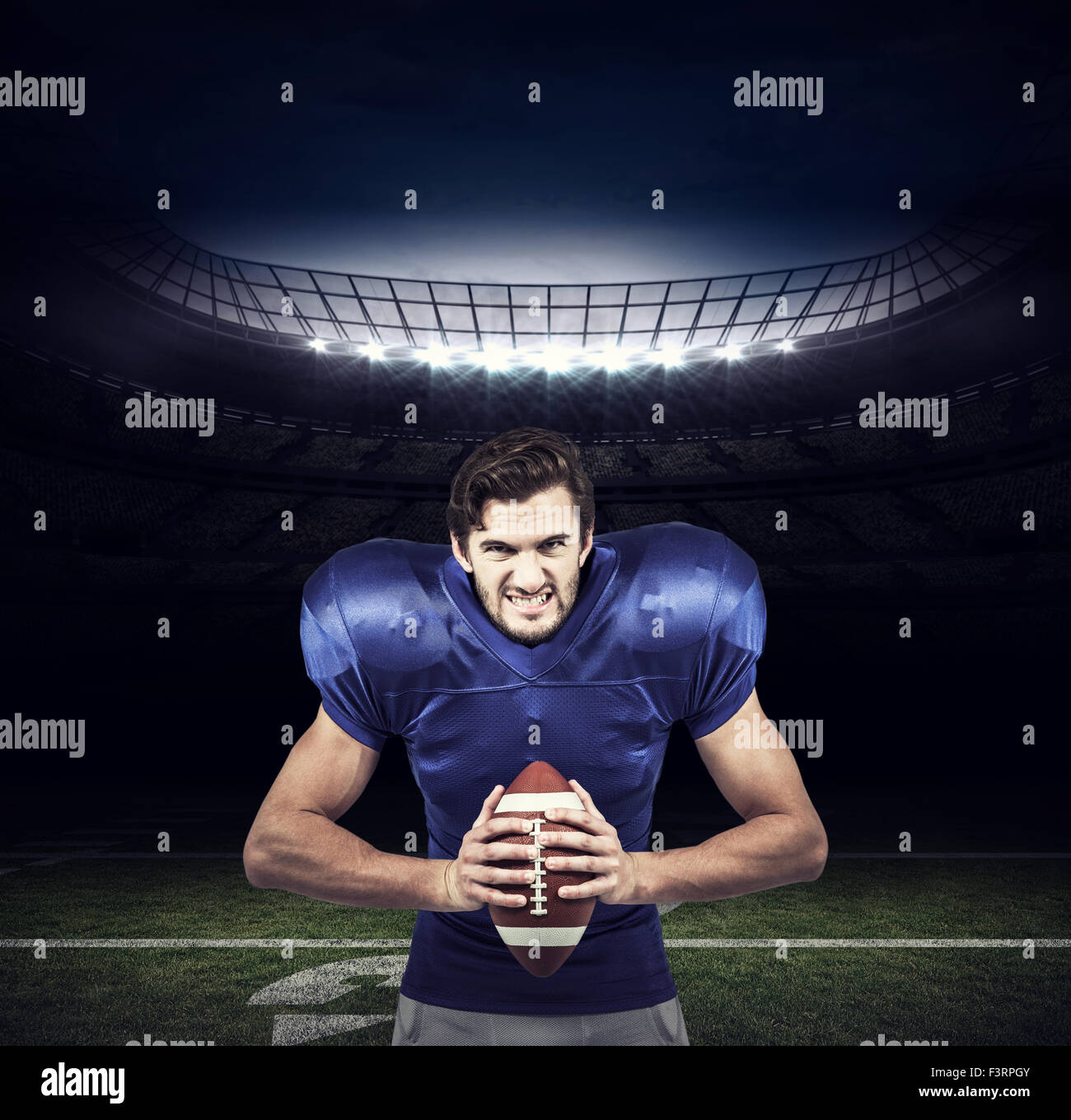 Composite image of aggressive american football player holding ball ...