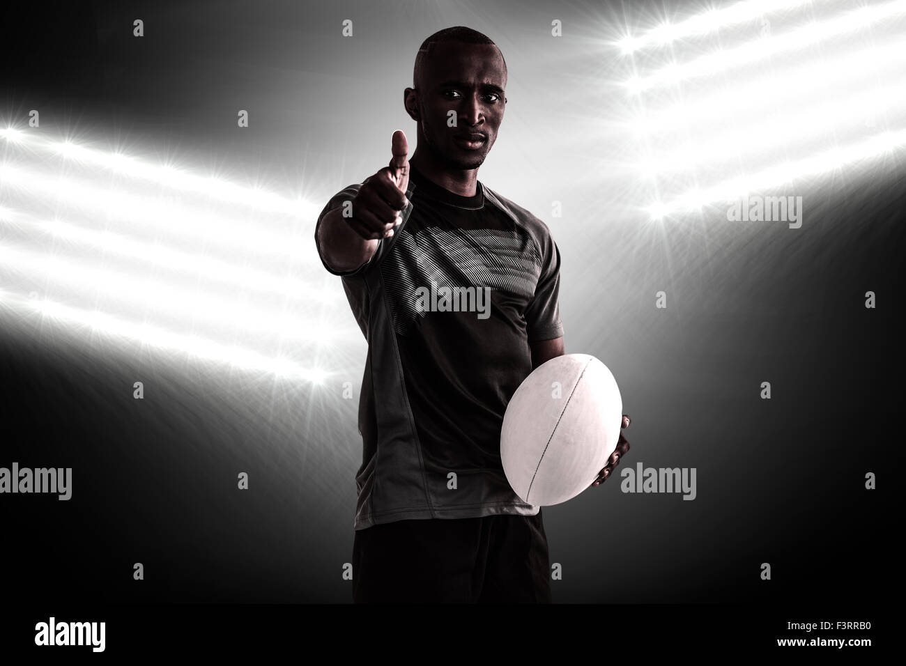 Composite image of portrait of confident rugby player showing thumbs up ...