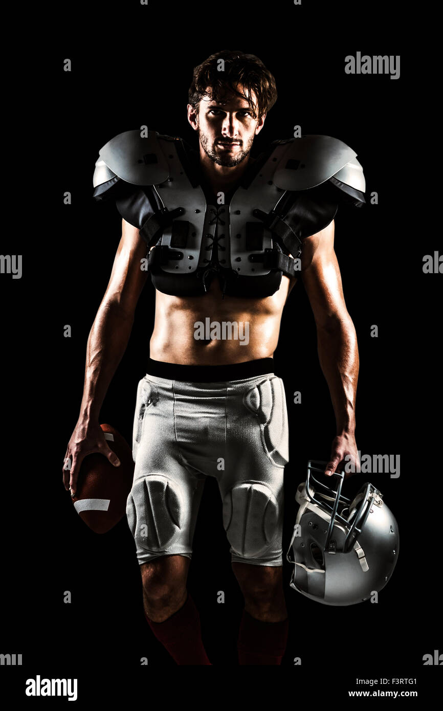 Composite image of shirtless american football player with padding ...