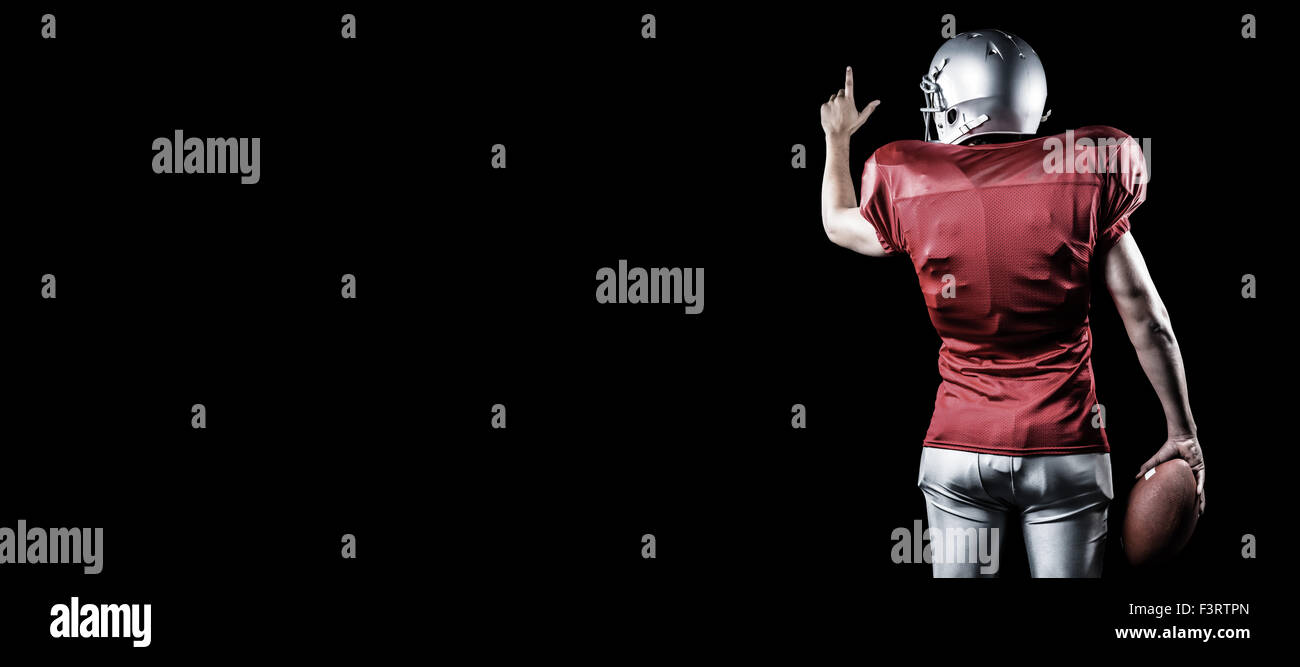 Composite image of rear view of american football player pointing while ...