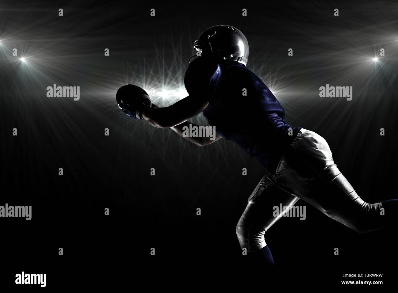 Composite image of silhouette american football player catching ball ...