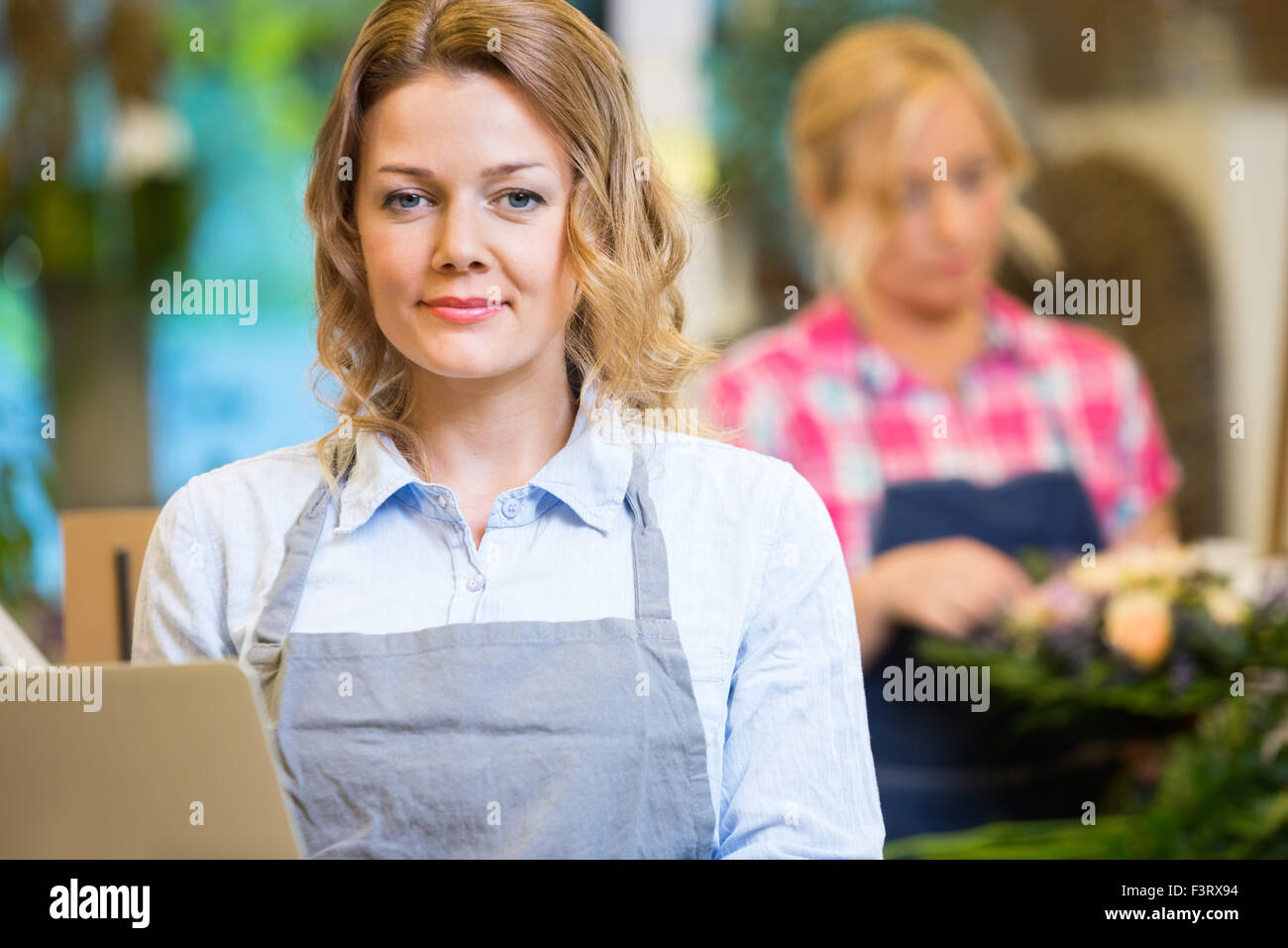 Portrait Of Beautiful Female Florist In Flower Shop Stock Photo - Alamy