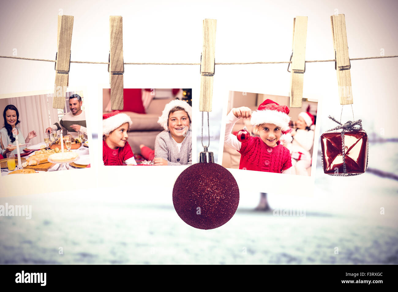 Composite image of hanging christmas photos Stock Photo - Alamy