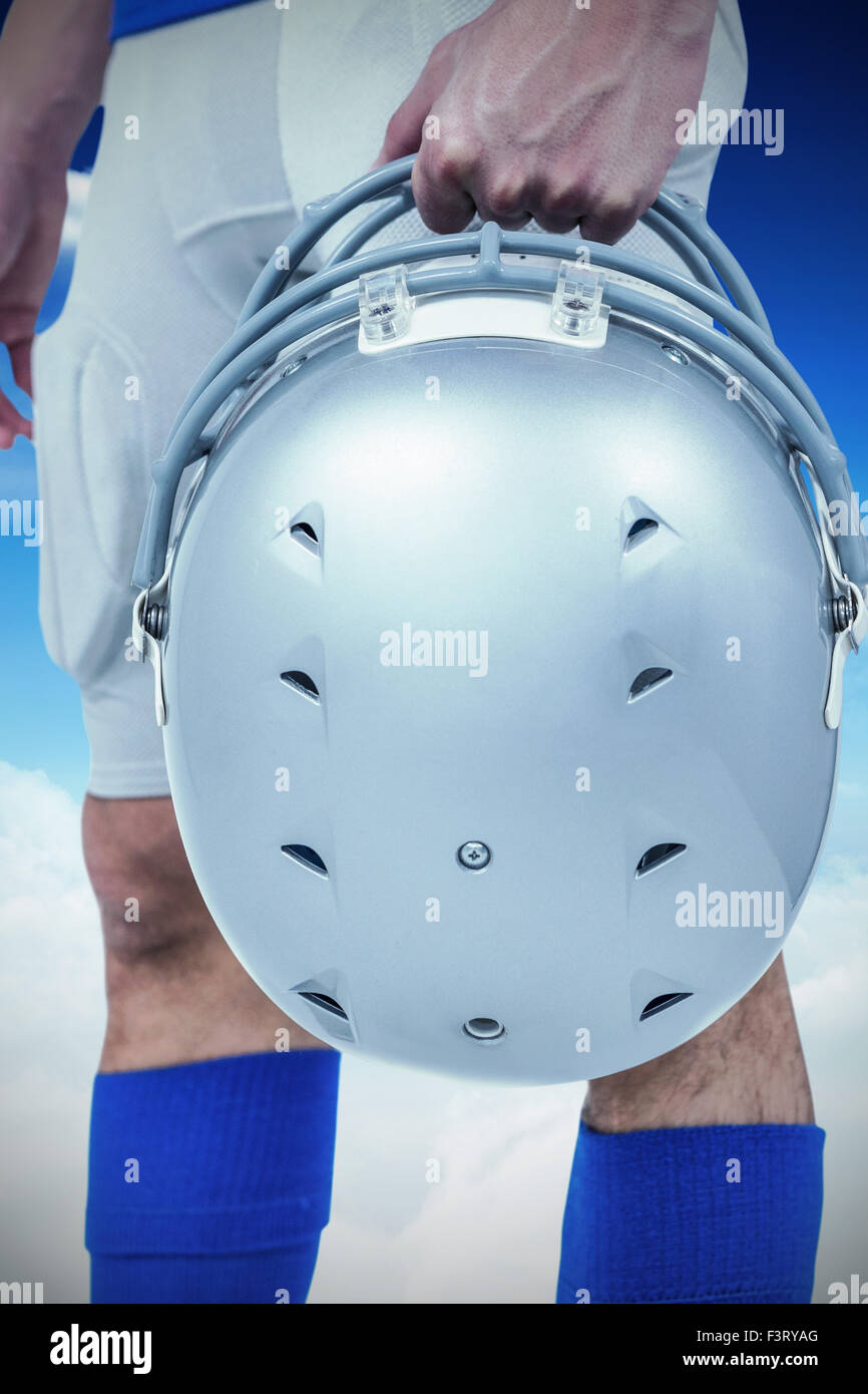Composite image of midsection of american football player handing his ...
