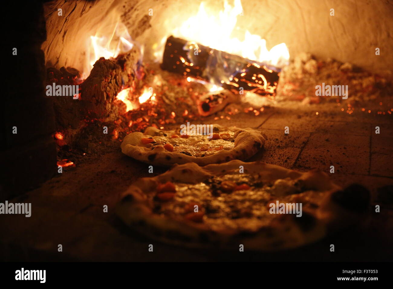 Wood fired pizza being made in alley by street vendor King Dough Pizza ...