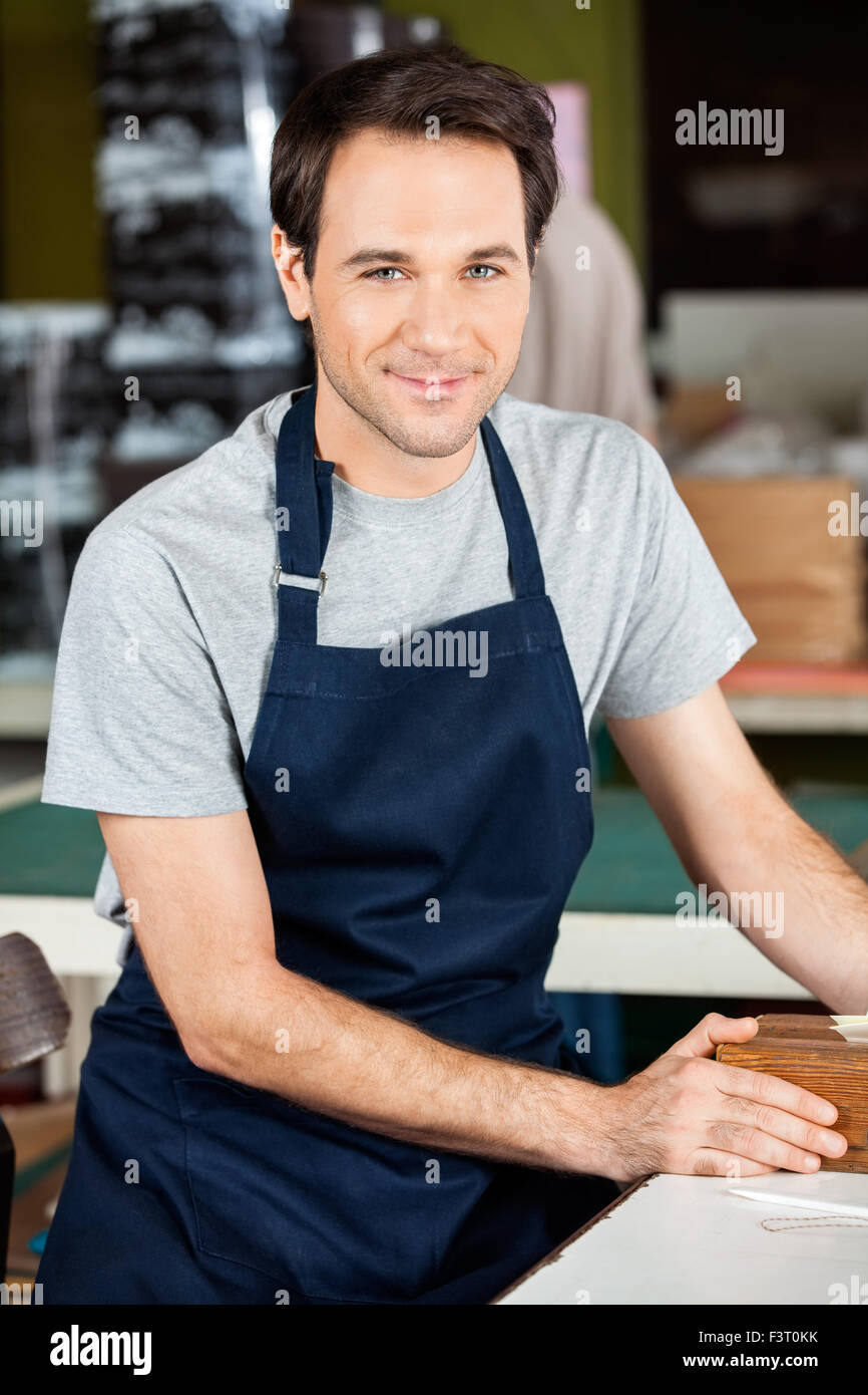 Confident Worker Wearing Blue Apron In Paper Factory Stock Photo - Alamy
