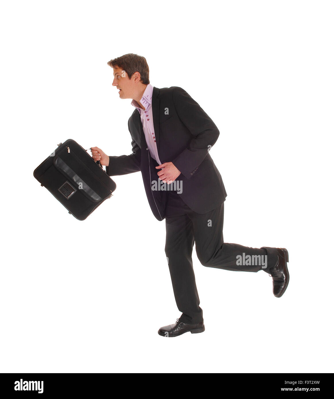 A running businessman in a dark suit and a briefcase in his hand ...