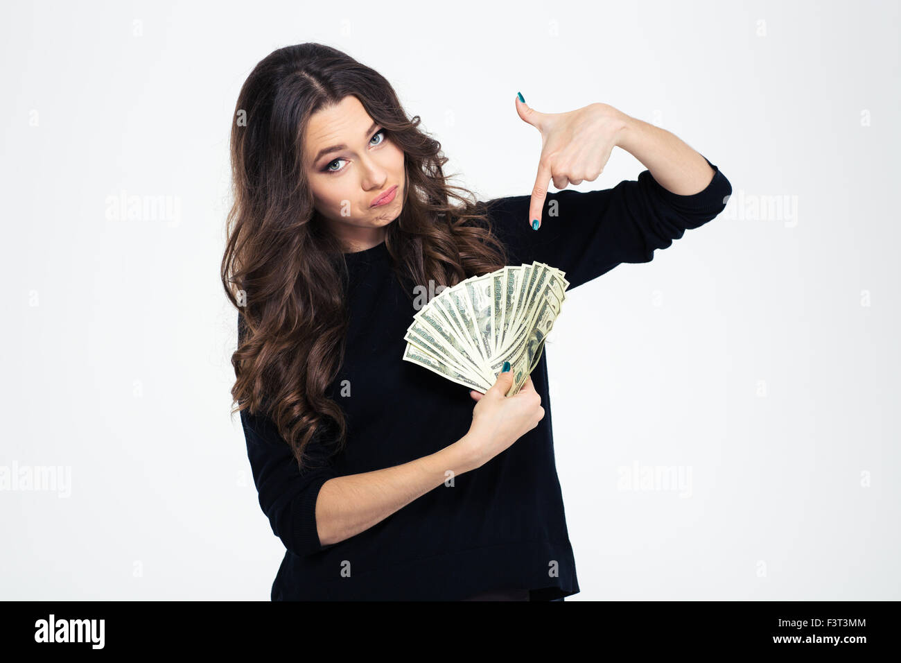 Portrait of a young beautiful girl pointing finger on dollar bills ...
