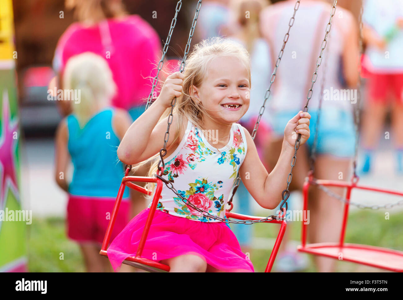 Little girl at fun fair Stock Photo - Alamy