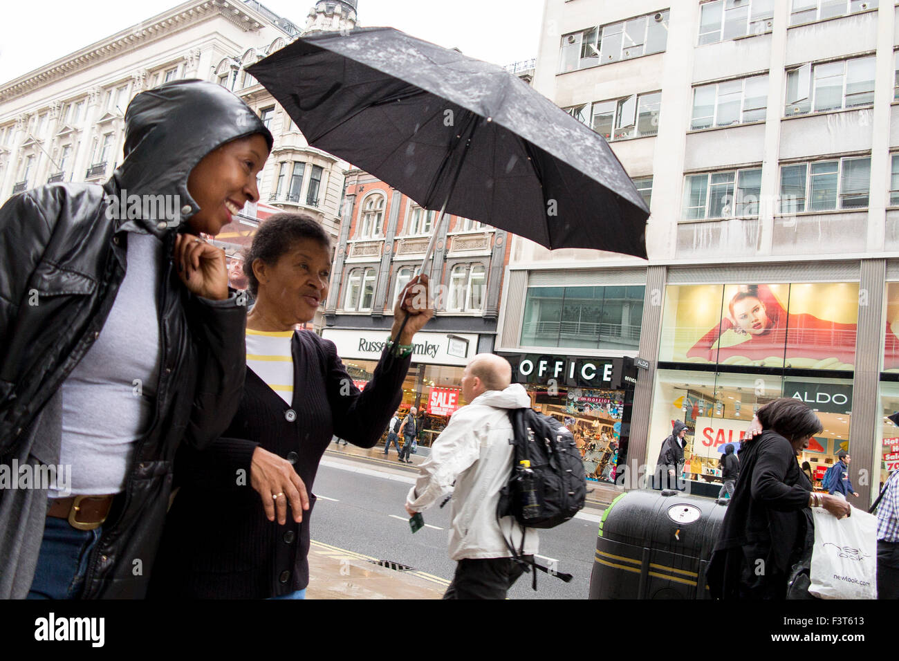 On a rainy day in London, people are out shopping on Oxford Street ...
